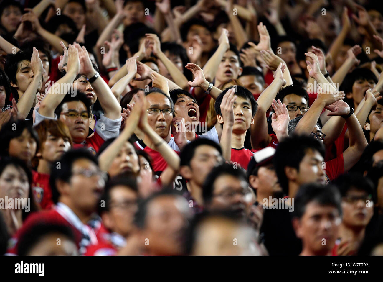 Football fans shout slogans to show support for Japan's Urawa Red ...