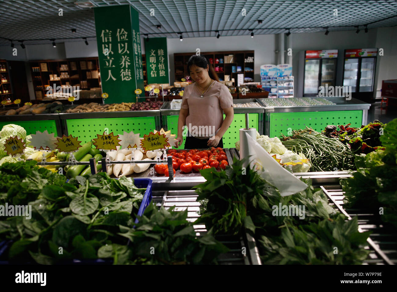 A customer shops in the self-service store at Julong town in Quanzhou ...