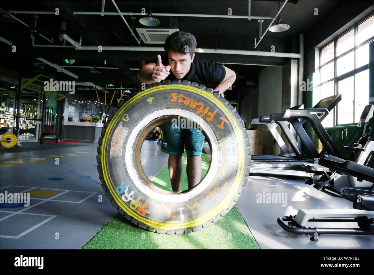 20-year-old Uzbekistan fitness instructor Alex exercises at a gym in ...