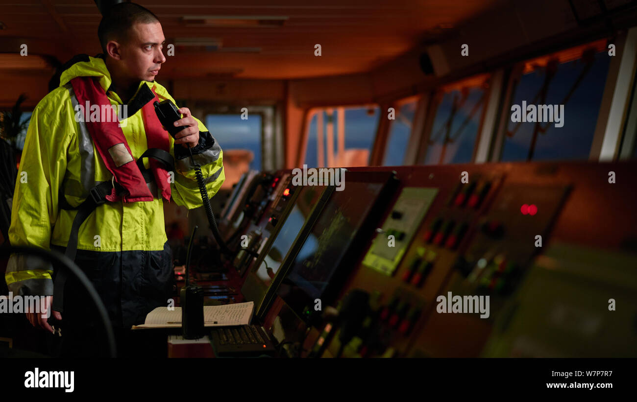 Navigator. pilot, captain as part of ship crew performing daily duties ...