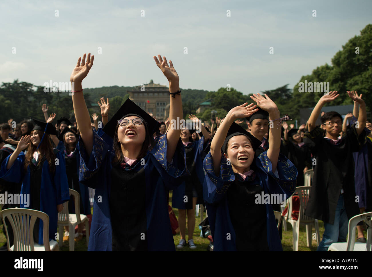 Graduates dressed in academic gowns take part in a graduation ceremony ...