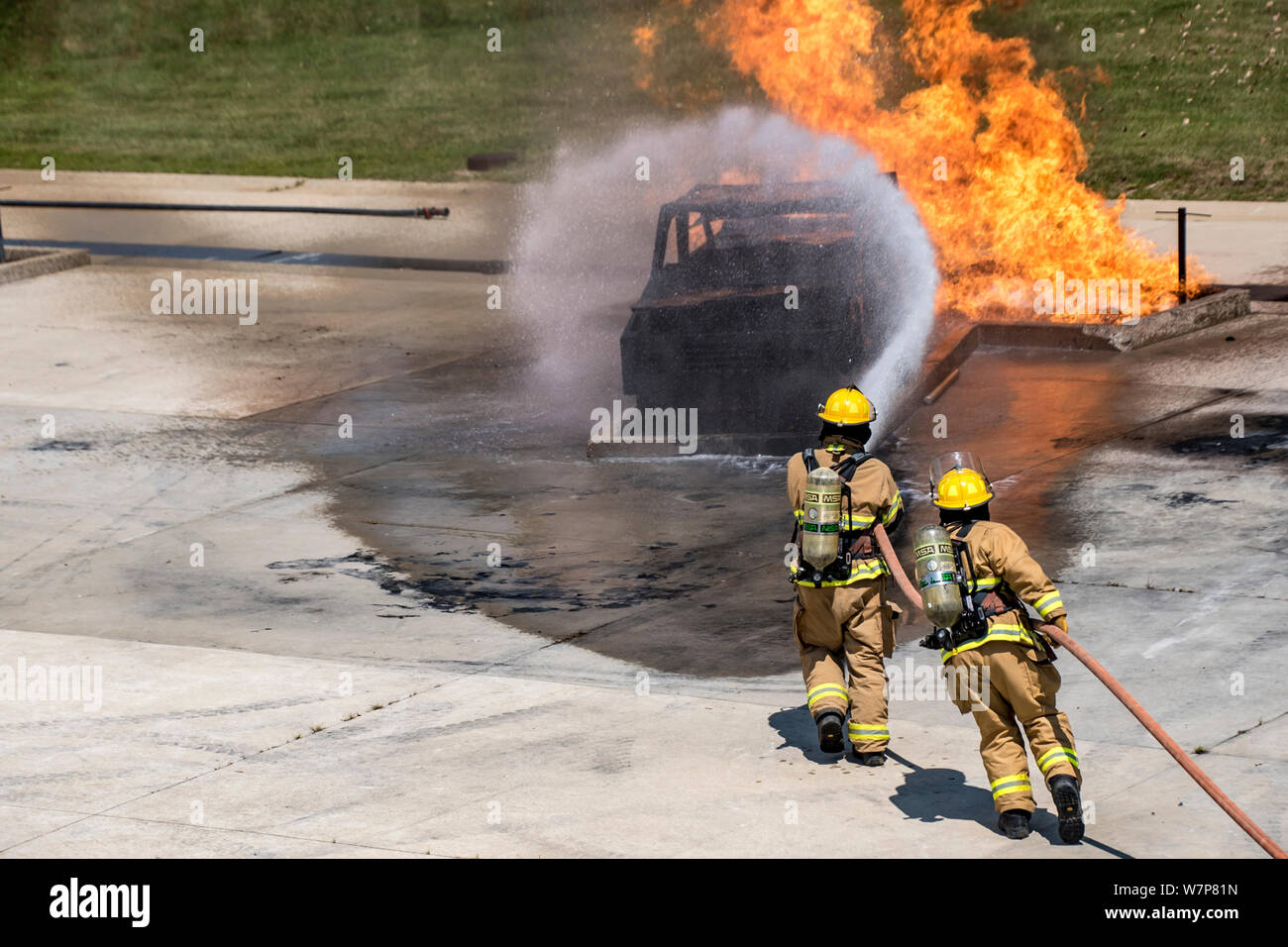 Members of the 121st Air Refueling Wing Fire Department train with a ...
