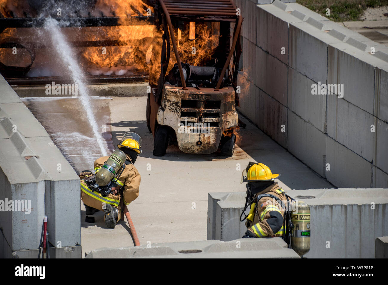 Members of the 121st Air Refueling Wing Fire Department train with a ...