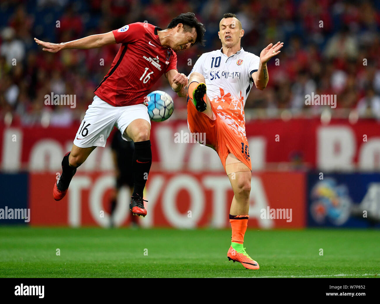 Takuya Aoki of Japan's Urawa Red Diamonds, left, challenges Marcelo ...
