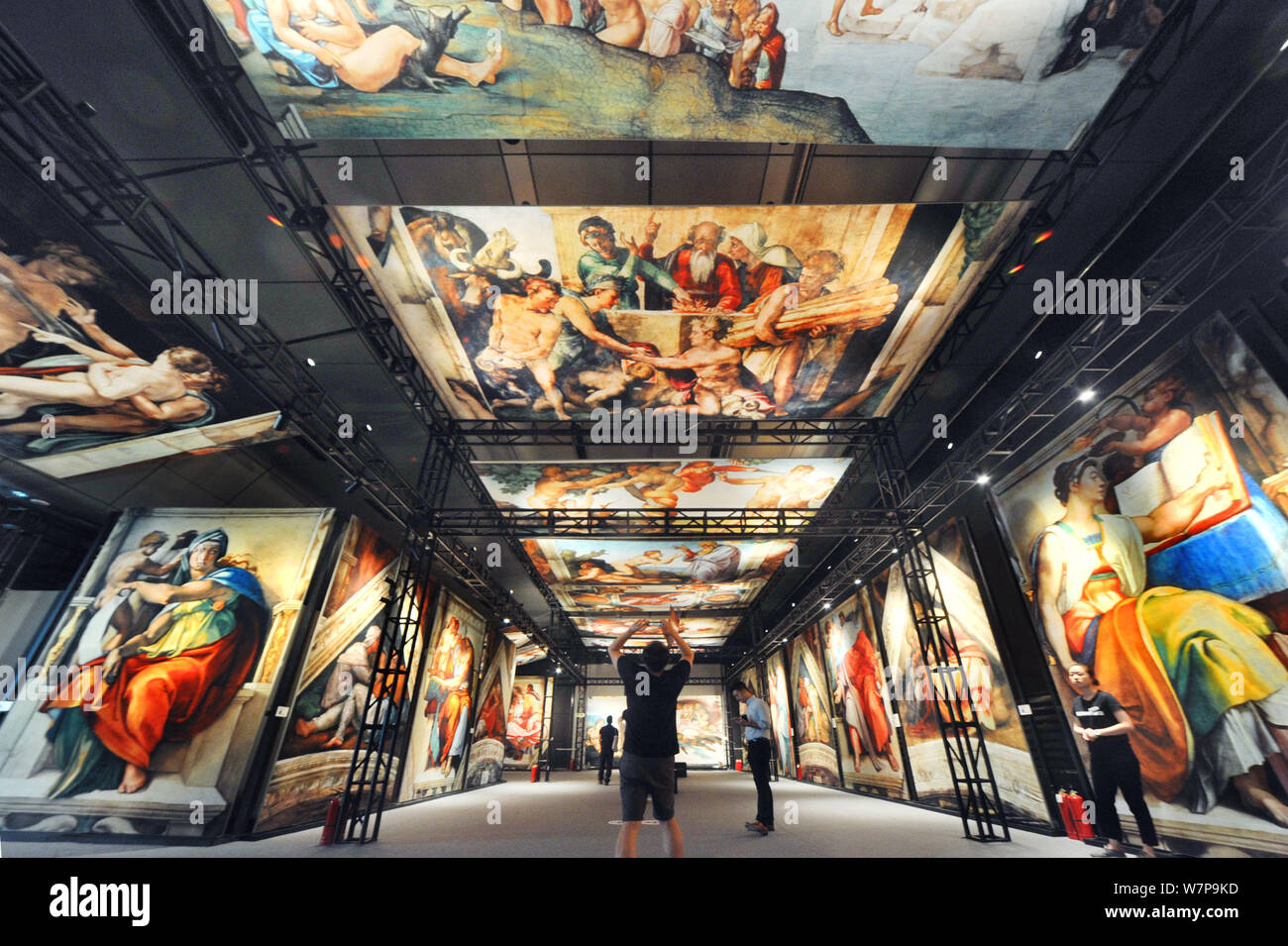 Visitors admire replicas of Michelangelo's murals at a preview of the ...