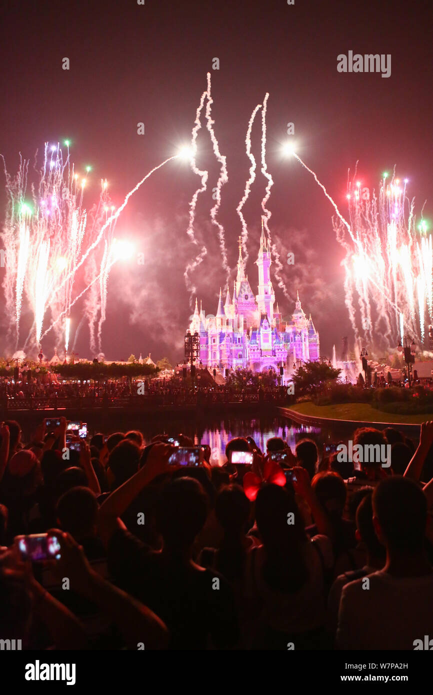 Fireworks explode over the Disney Castle during the first anniversary ...