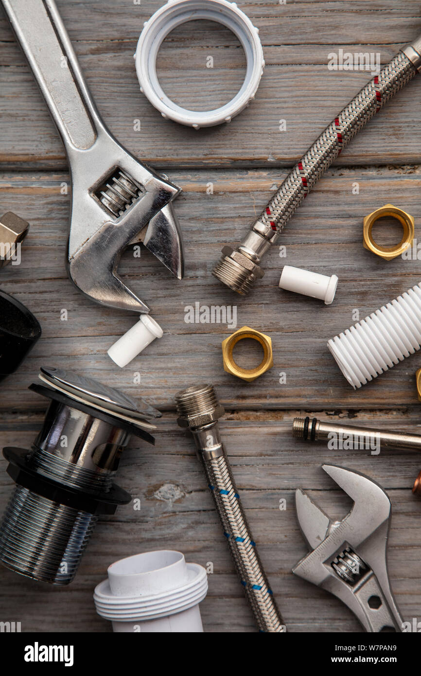Plumbing layout. Tools and acessories on a wooden background Stock ...