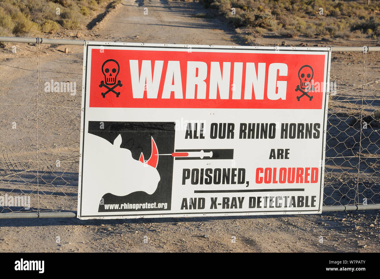 Warning sign explaining that rhino horns within reserve are poisoned ...