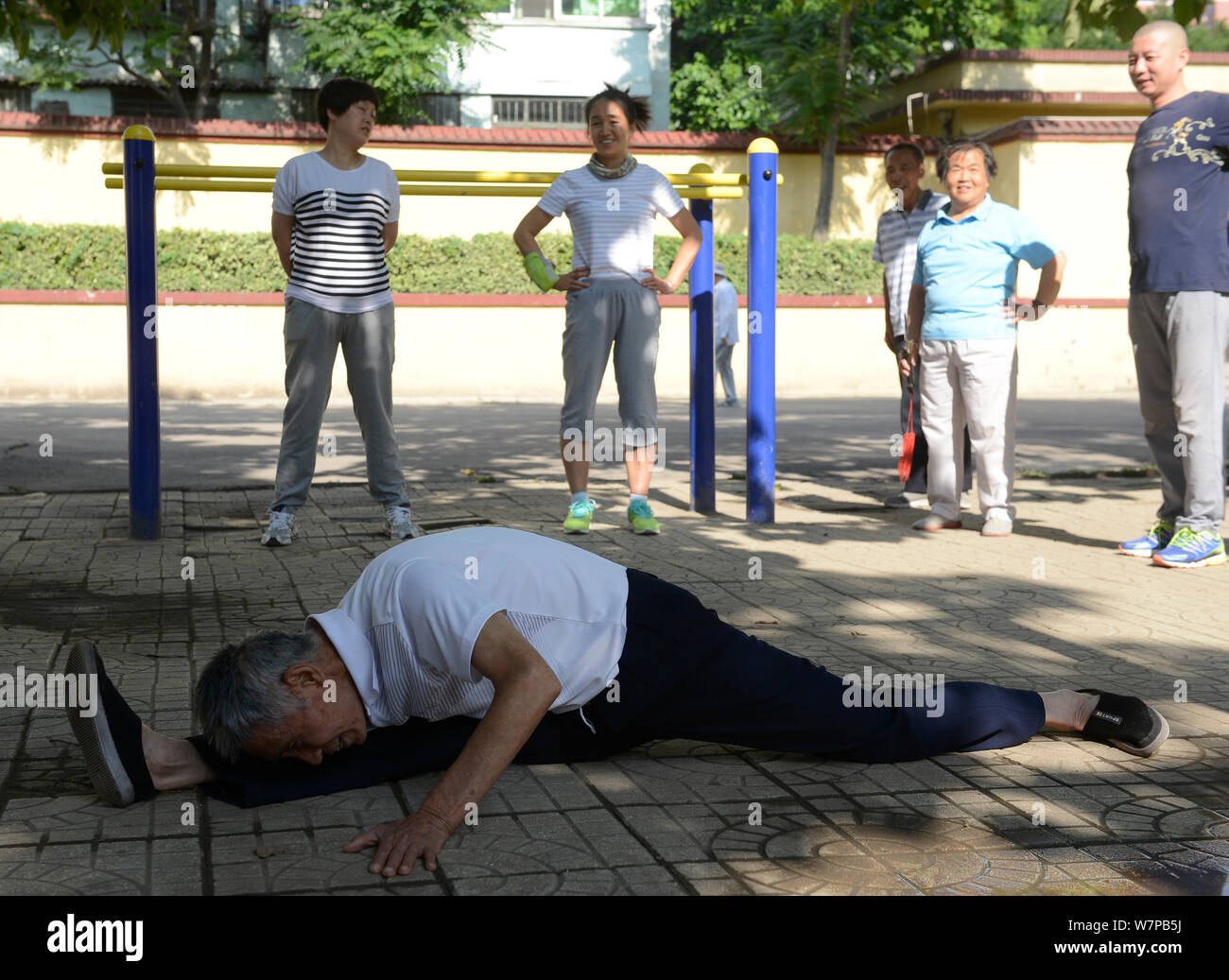 80-year-old Chinese man Wang Zhongwei is pictured as he does the splits to do morning exercises ...