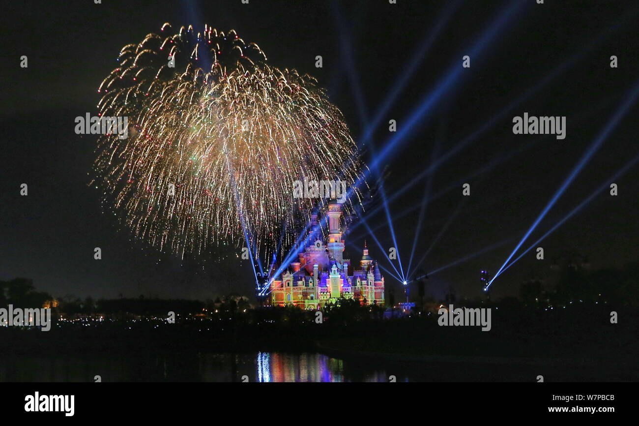 Fireworks explode over the Disney Castle during the first anniversary ...