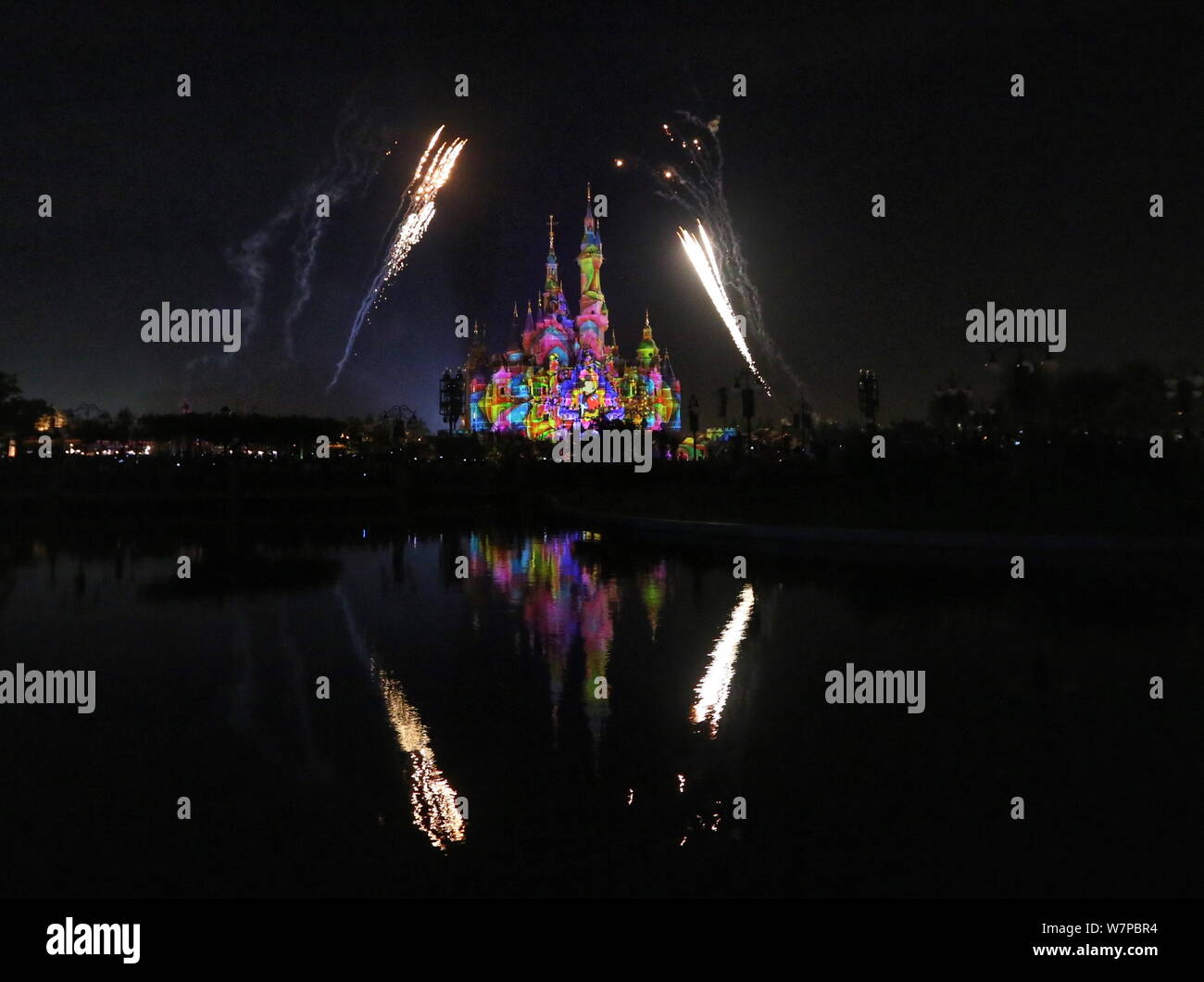 Fireworks explode over the Disney Castle during the first anniversary ...