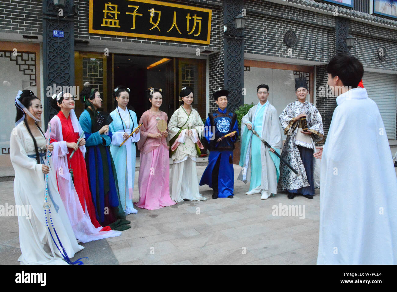 Chinese employees dressed in traditional costumes are pictured as they ...