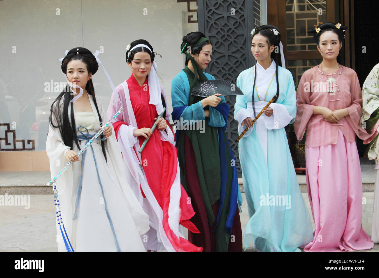 Chinese employees dressed in traditional costumes are pictured as they ...