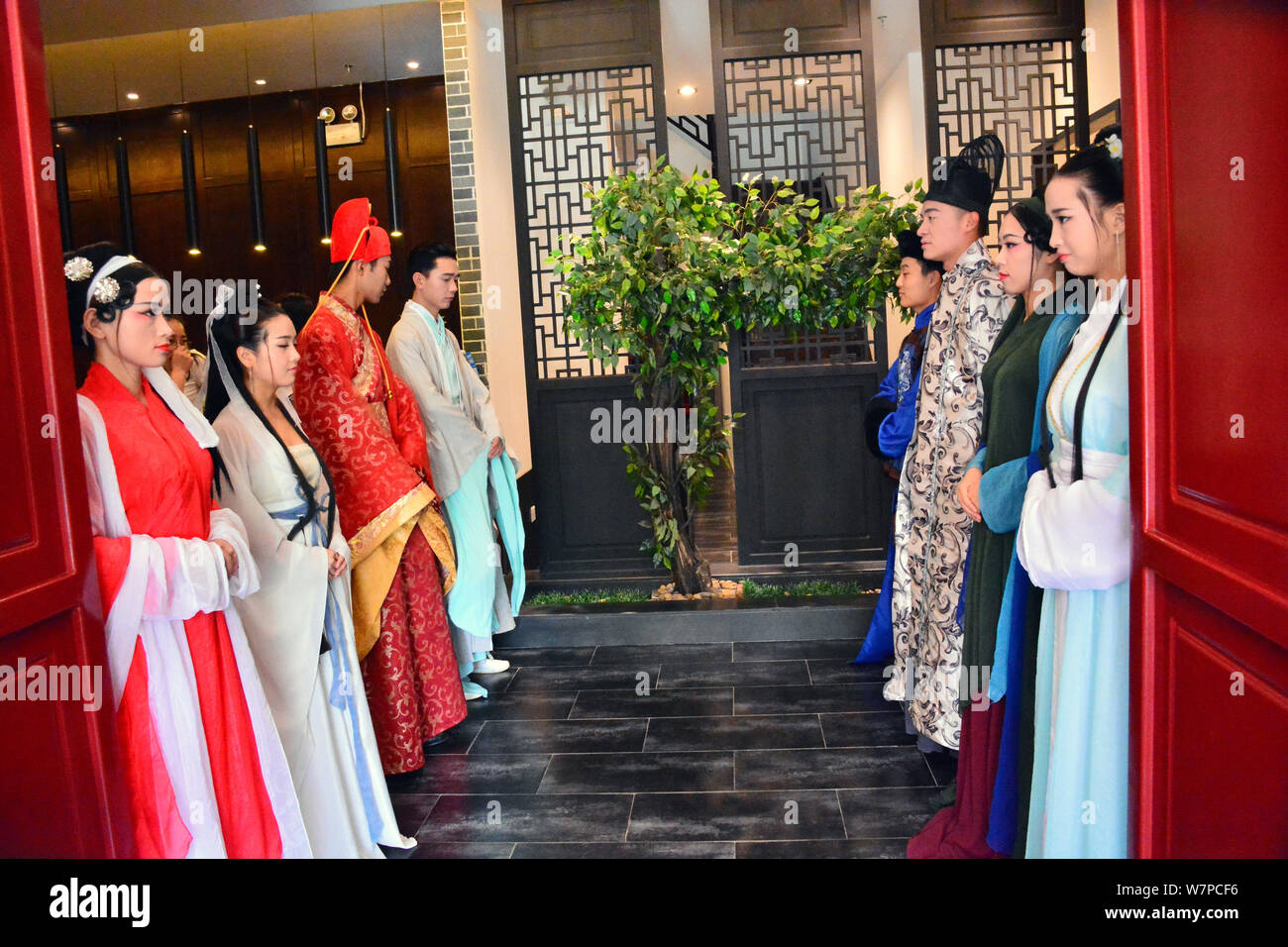 Chinese employees dressed in traditional costumes are pictured as they ...
