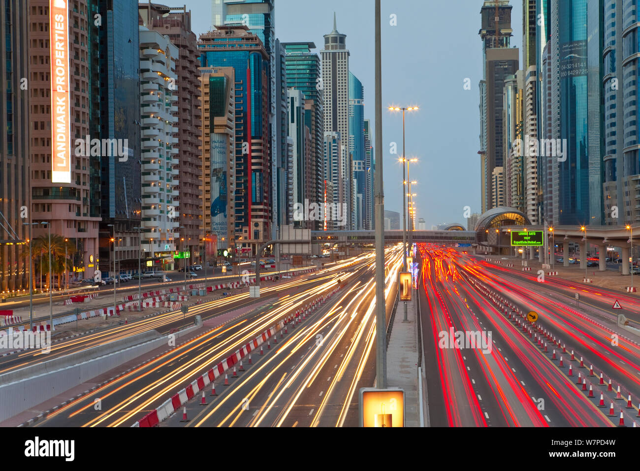 Sheikh Zayed Rd at dusk with traffic and new high rise buildings along ...