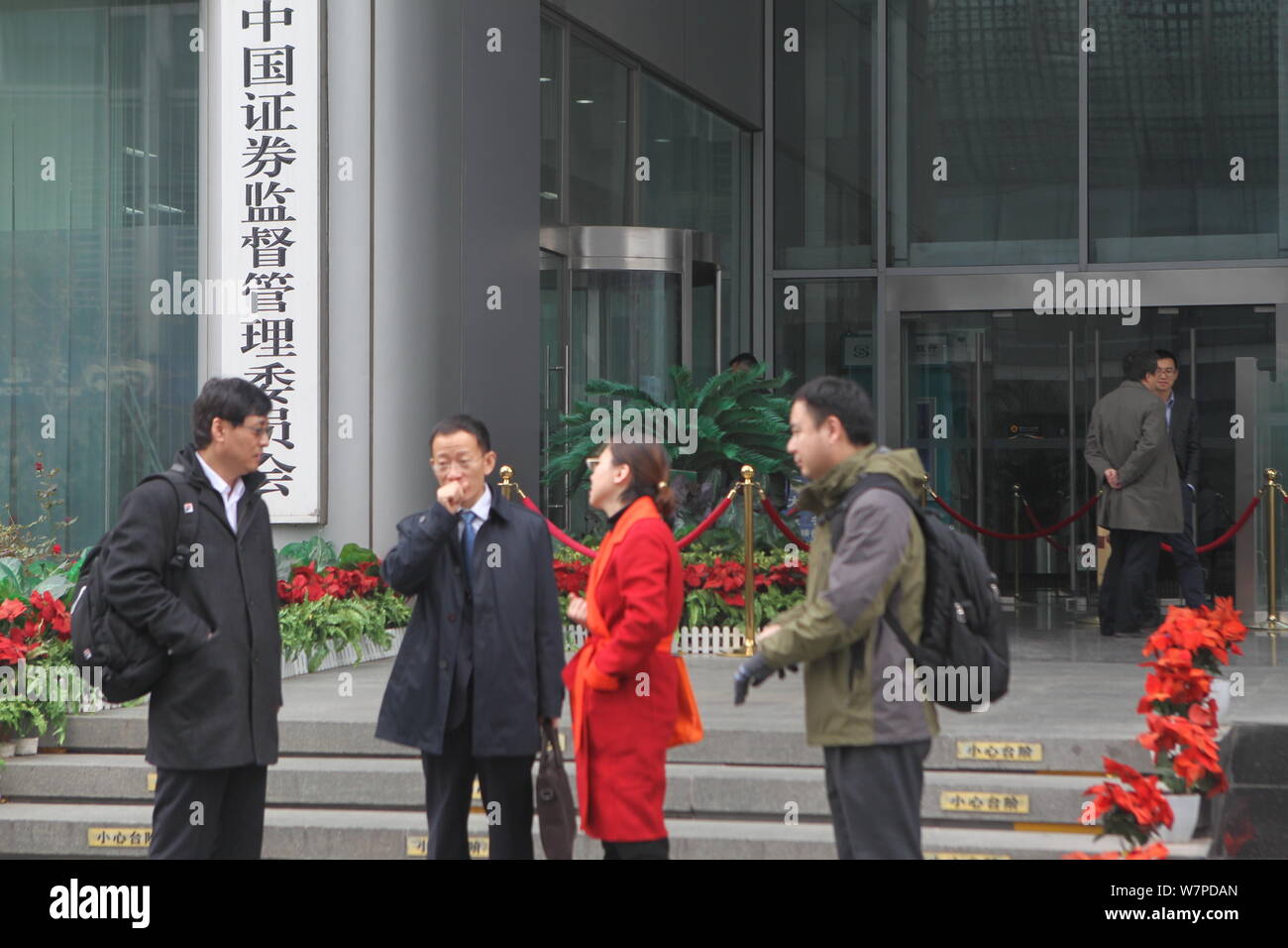 --FILE--Visitors talk in front of the headquarters of the China ...