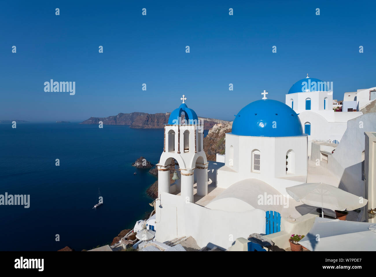 Blue domed churches in the village of Oia (La), Santorini (Thira), Cyclades Islands, Aegean Sea ...