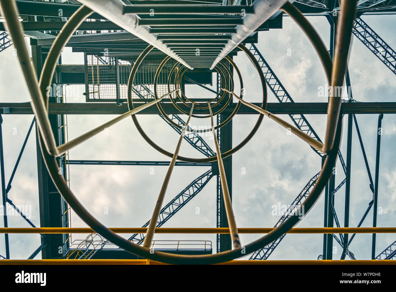 industrial metal ladder with round protection railing Stock Photo - Alamy