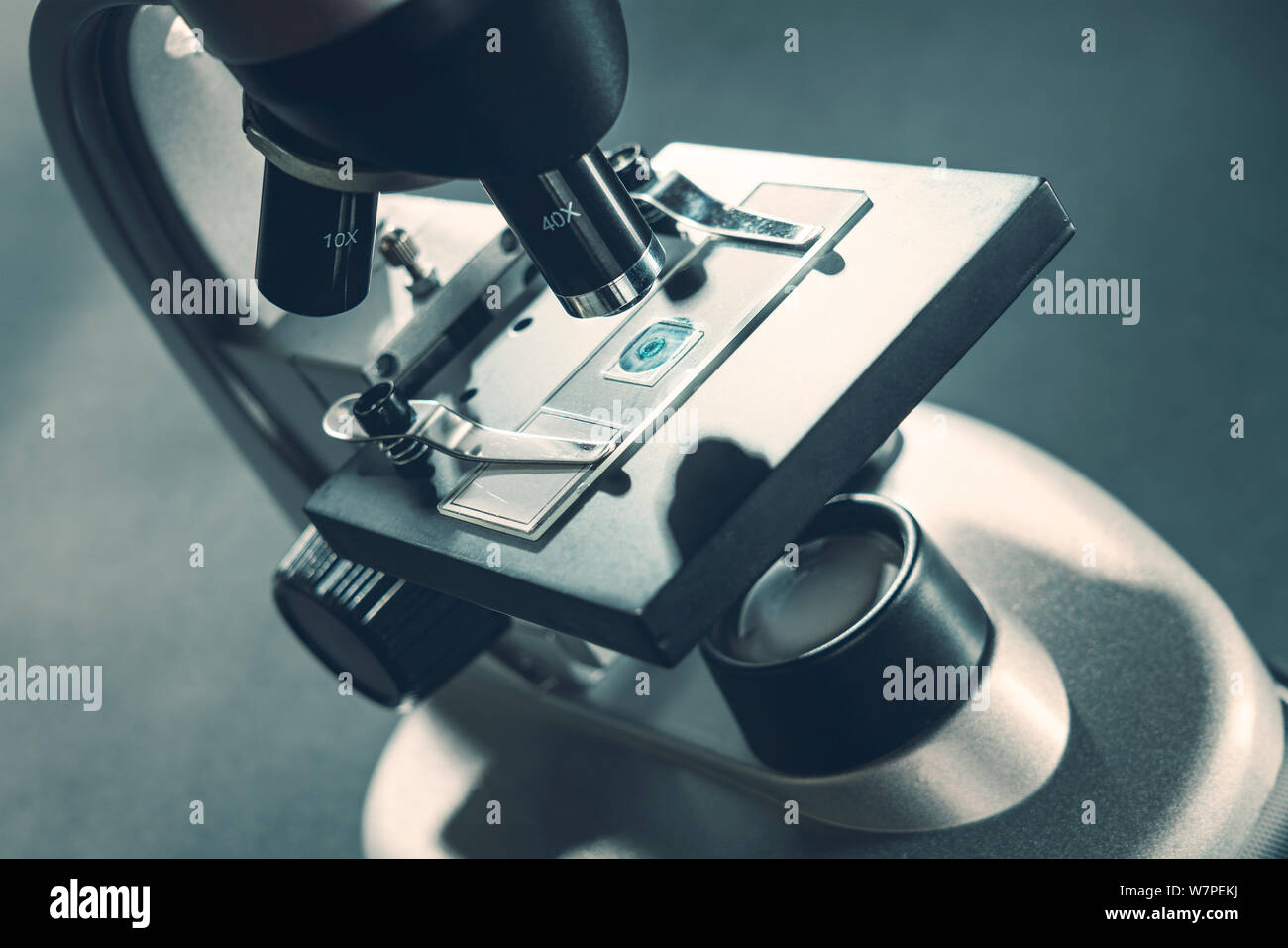 details of a silver microscope, with black background Stock Photo - Alamy