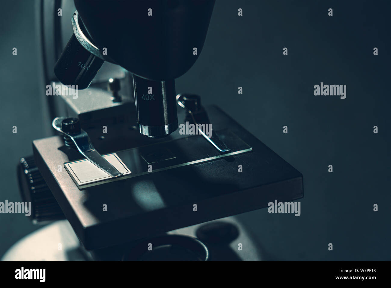 details of a silver microscope, with black background Stock Photo - Alamy