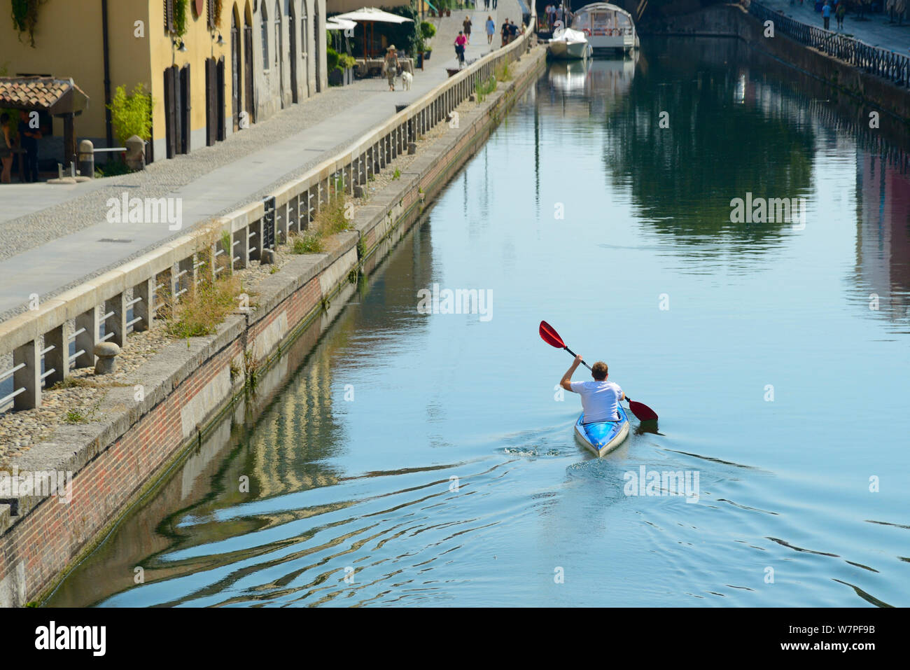 Italy, Lombardy, Milan, Naviglio Grande Canal, Man Paddling Canoe Stock ...