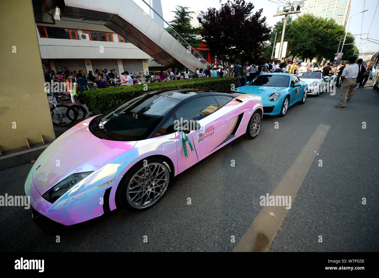 Sports cars arrive at the Shandong Experimental High School as part of ...