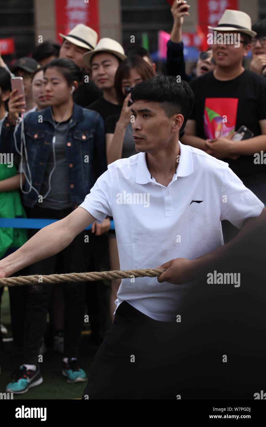 Chinese teacher Yu Yang shows his rich expressions during a tug-of-war ...