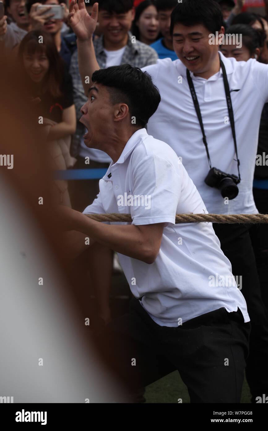 Chinese teacher Yu Yang shows his rich expressions during a tug-of-war ...