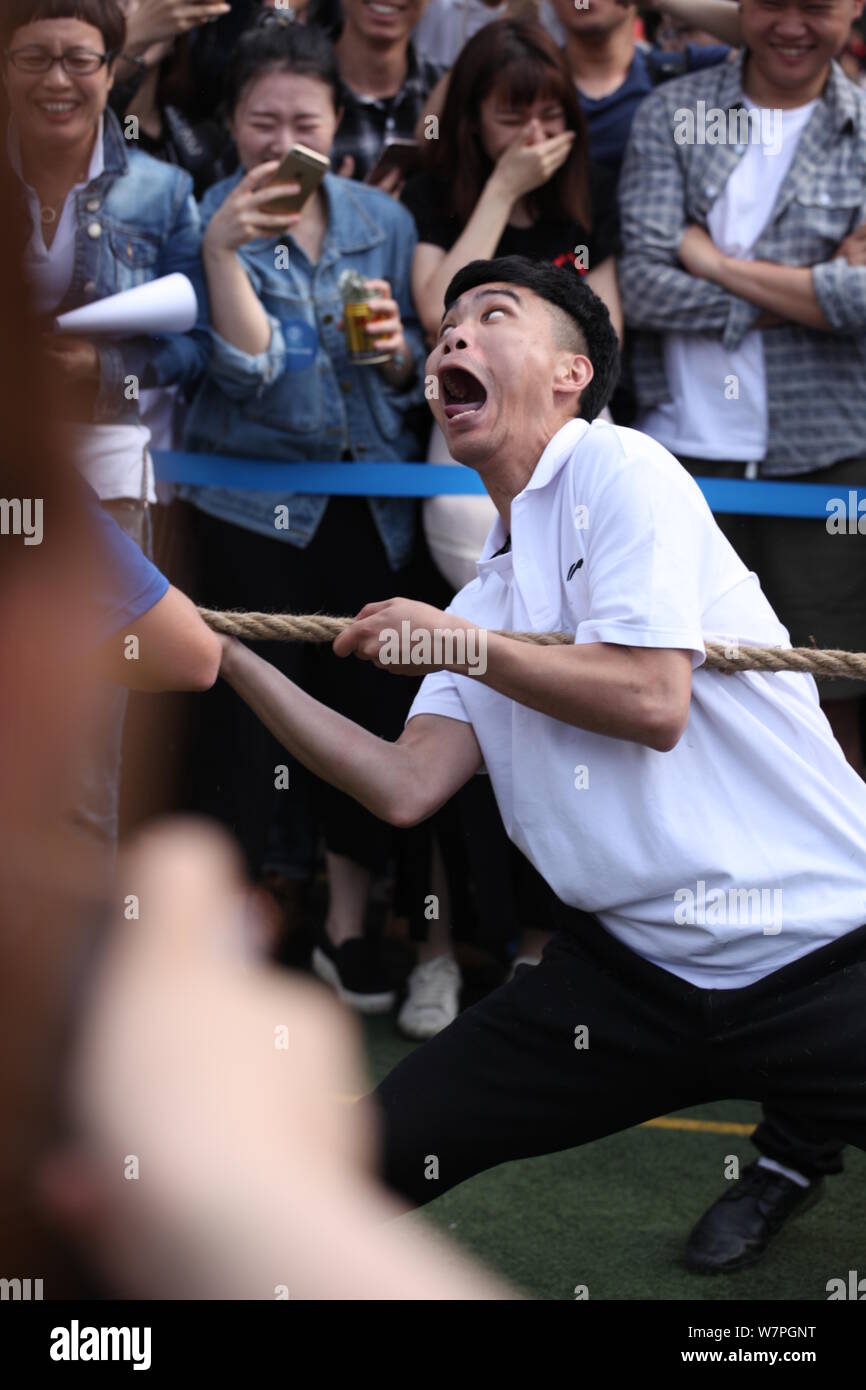 Chinese teacher Yu Yang shows his rich expressions during a tug-of-war ...