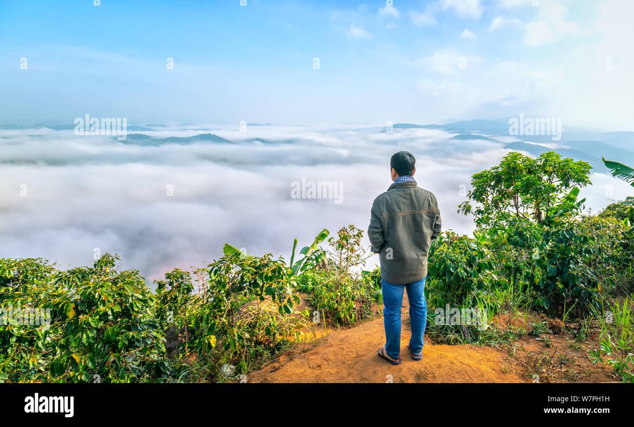 Silhouette of man standing on a high hill scenic rural hometown in the ...