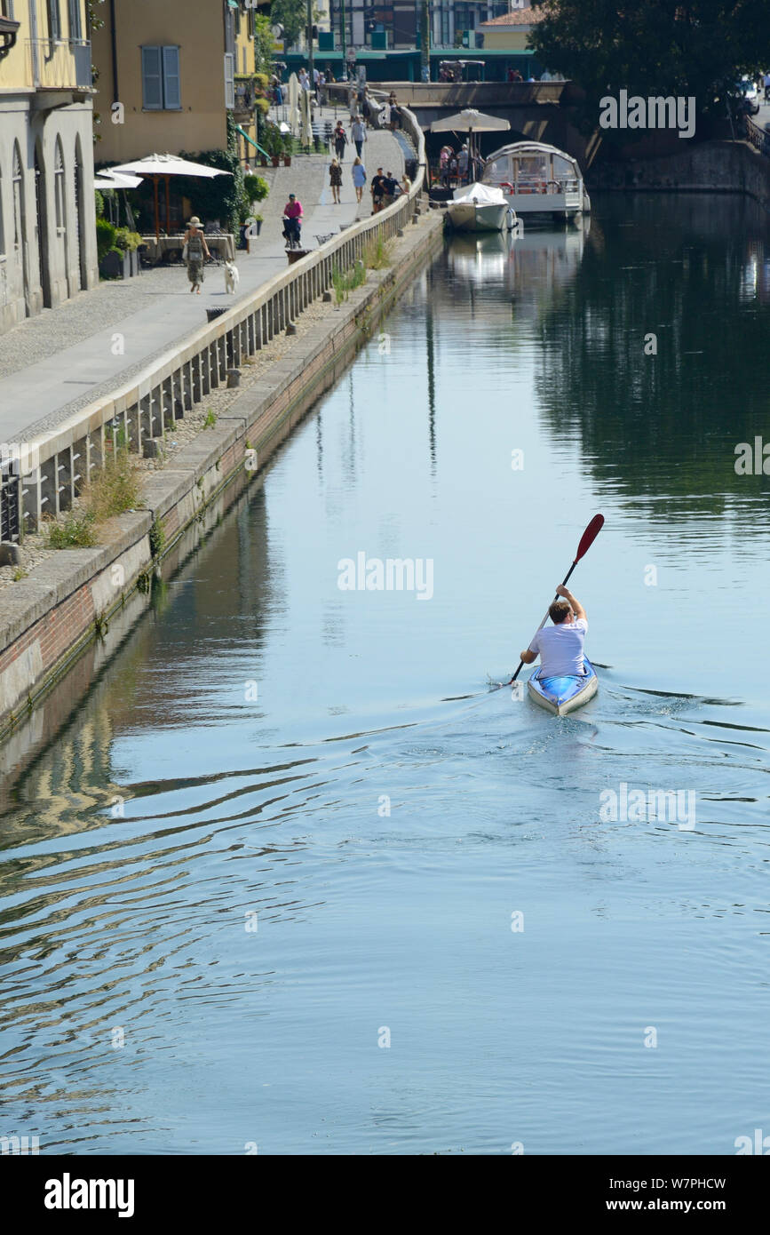 Italy, Lombardy, Milan, Naviglio Grande Canal, Man Paddling Canoe Stock ...