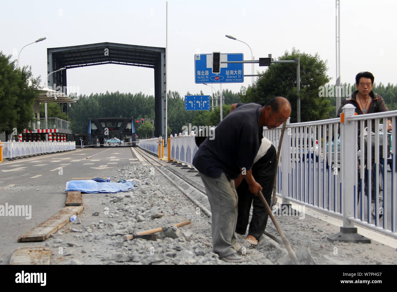 Chinese workers demolish the special tracks for the test drive of the ...