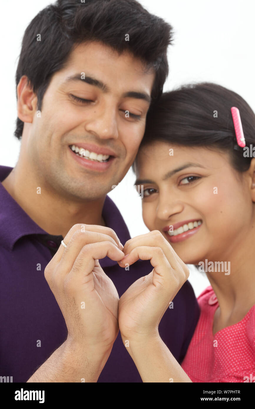 Young married couple making heart hi-res stock photography and images ...
