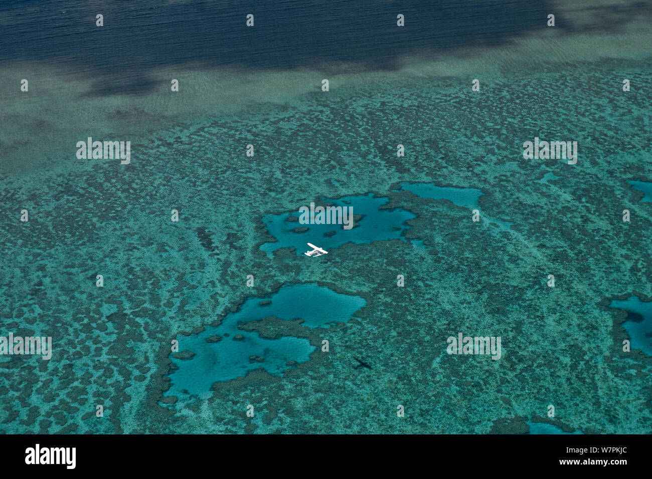 Aerial view of Hardy Reef with float plane, Great Barrier Reef, August ...
