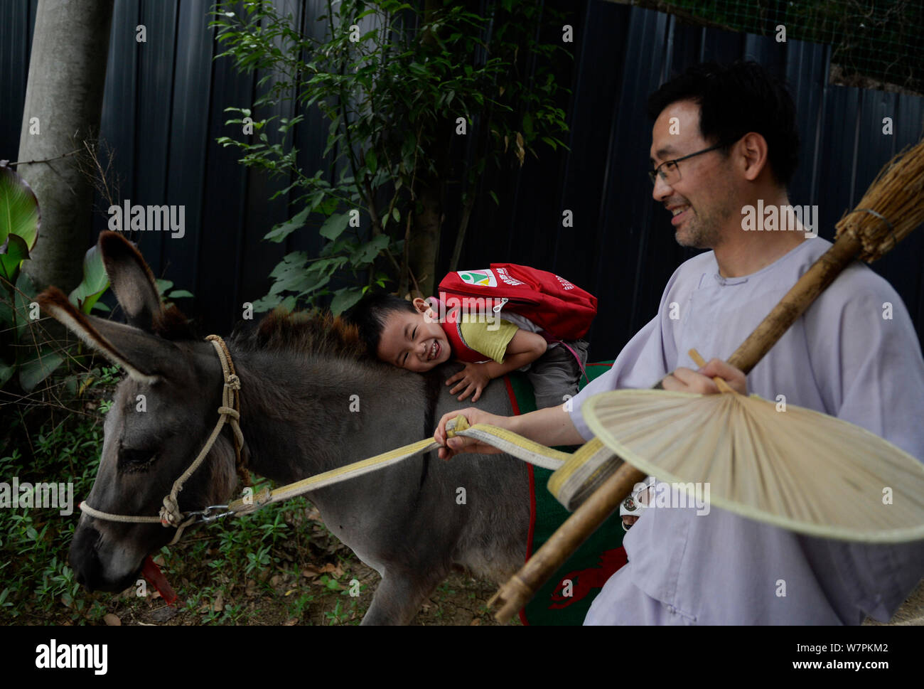 The three-year-old child is on the way to go to preschool on the back ...