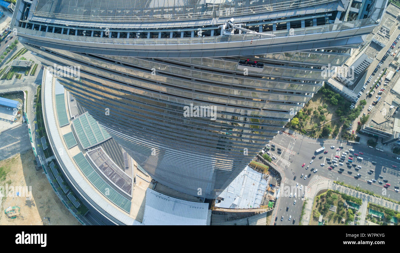 Chinese migrant workers clean the exterior window of the 350-meter-high ...