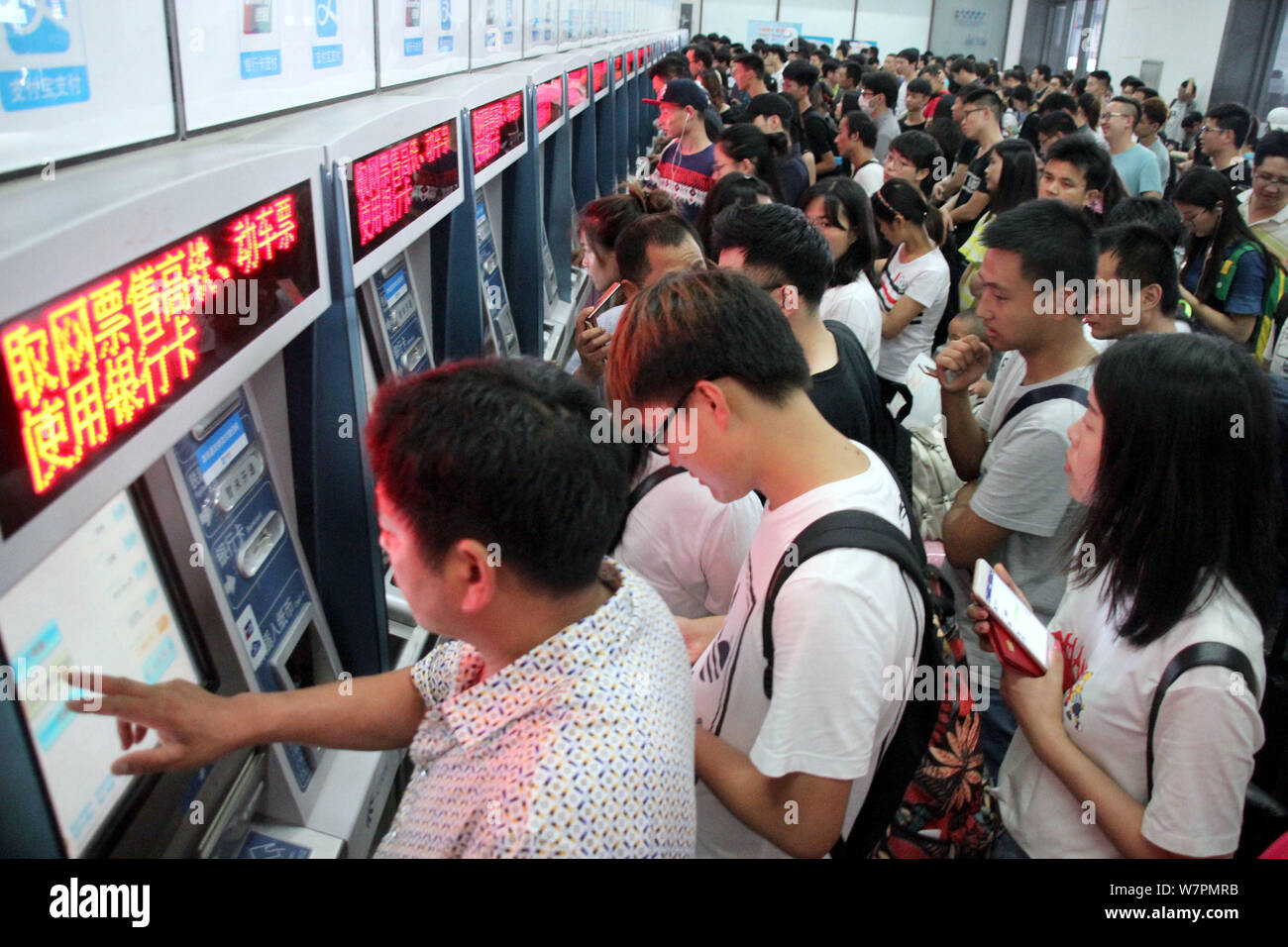 A crowd of Chinese passengers queue up to buy tickets at the Suzhou ...