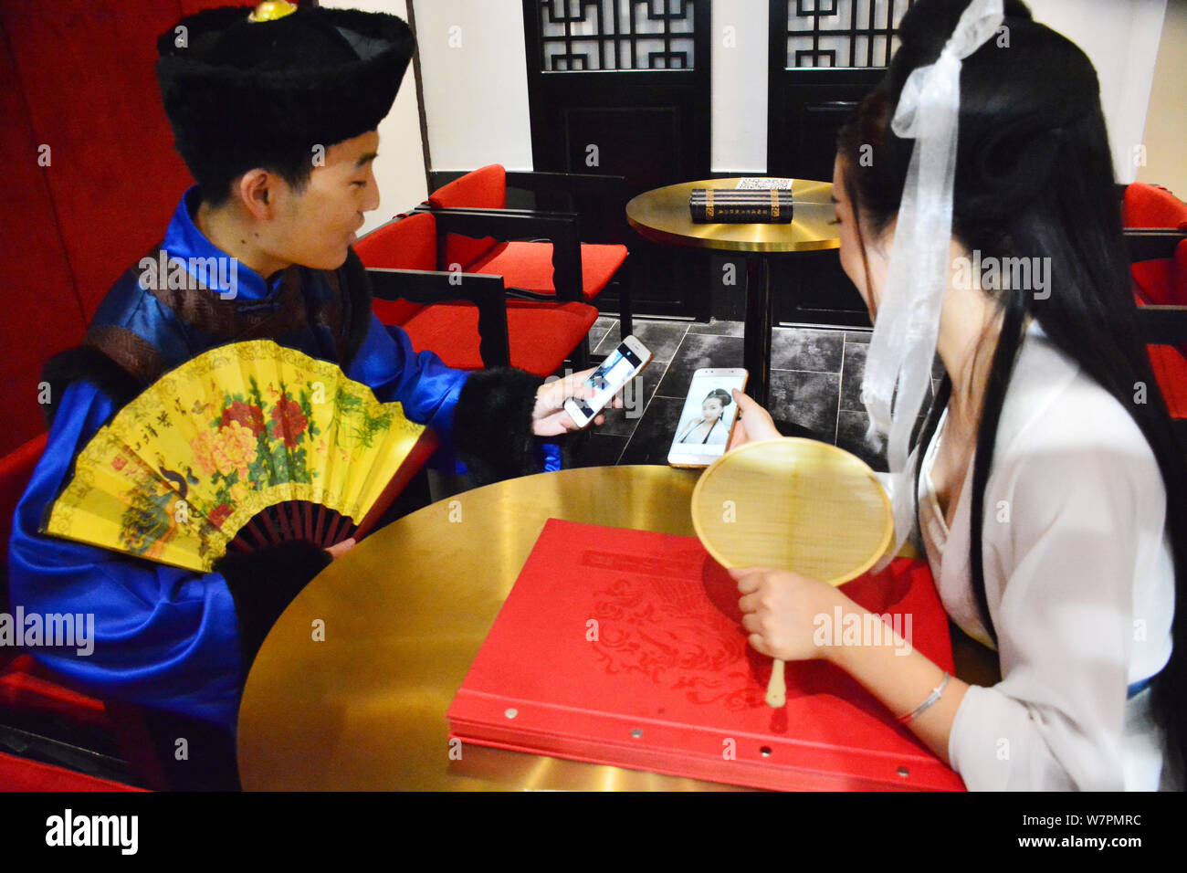 A Chinese employee dressed in traditional costume is pictured as she ...