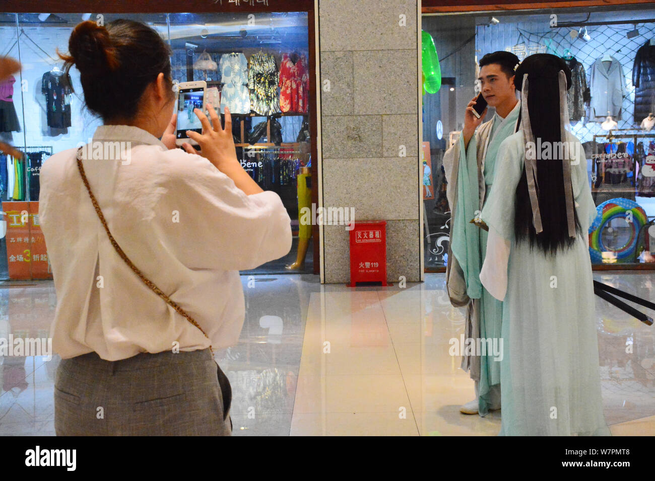Chinese employees dressed in traditional costumes are on the way to go ...