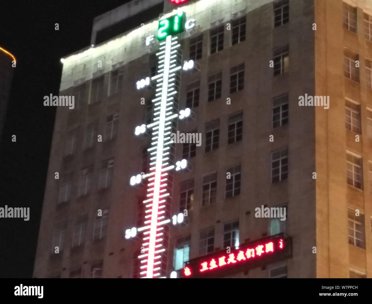 View of a building with the huge thermometer showing outdoor ...