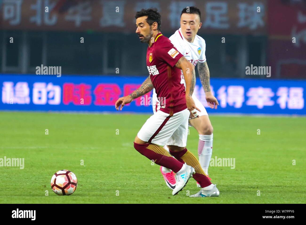 Argentine football player Ezequiel Lavezzi, left, of Hebei China ...