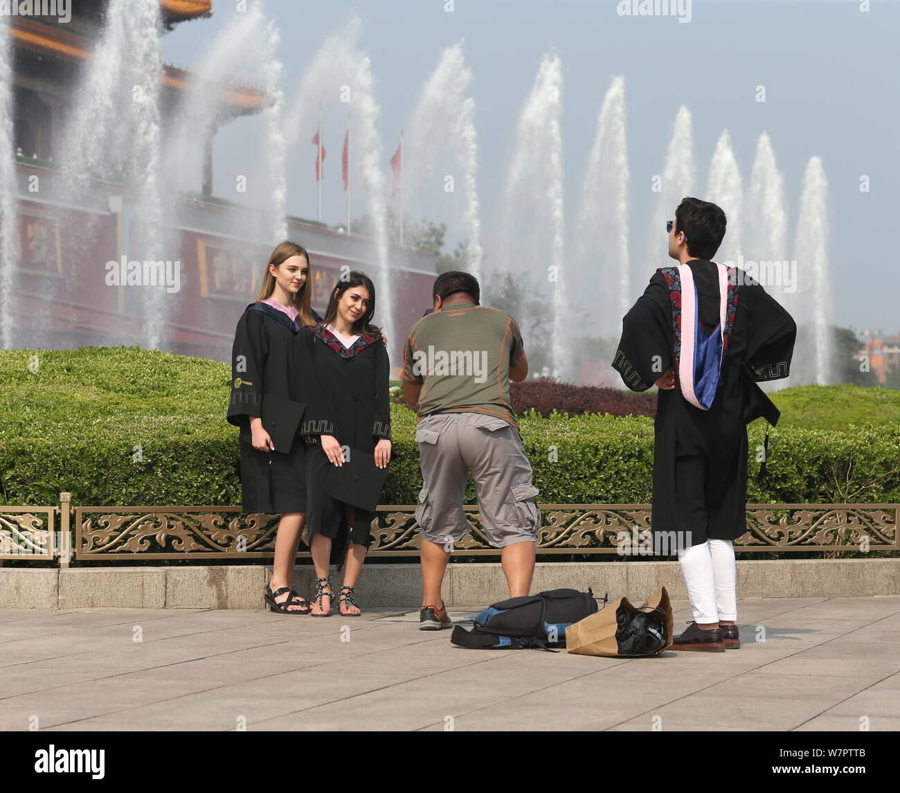 International students pose for graduation photos at the Tian'anmen ...