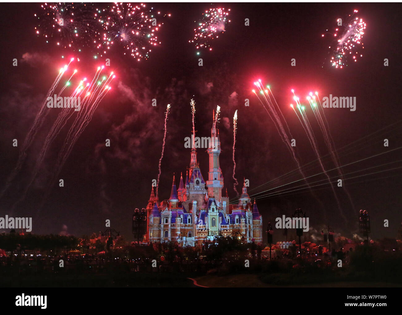 Fireworks explode over the Disney Castle during the first anniversary ...
