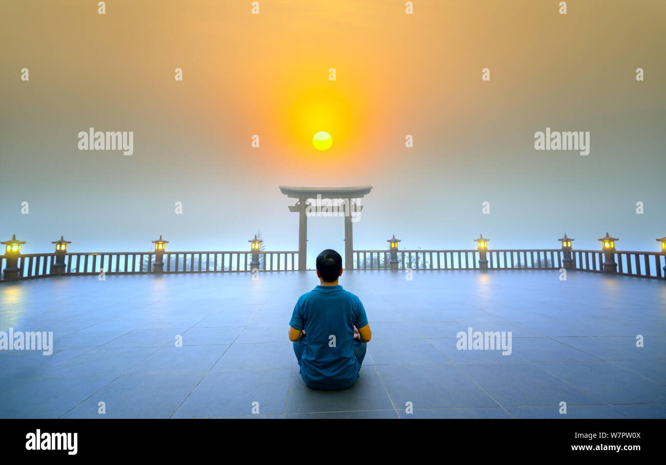 Silhouette of man in meditation posture temple near Bao Loc, Vietnam ...