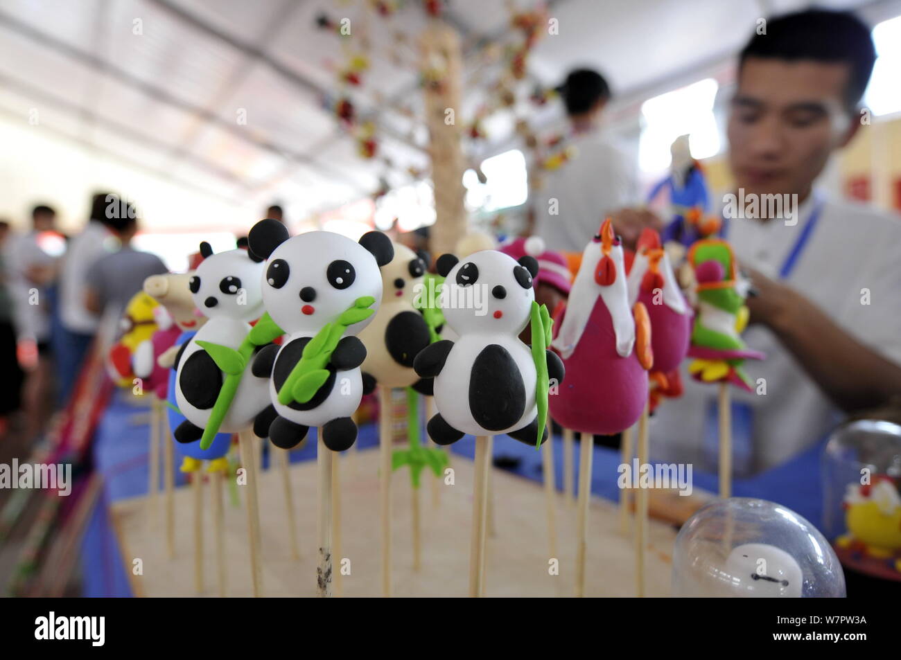 Chinese folk artist Han Hongyuan makes a dough figurine, made of sticky ...