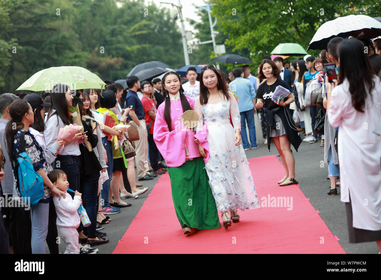 Students walk on the red carpet for a graduation party held by the ...