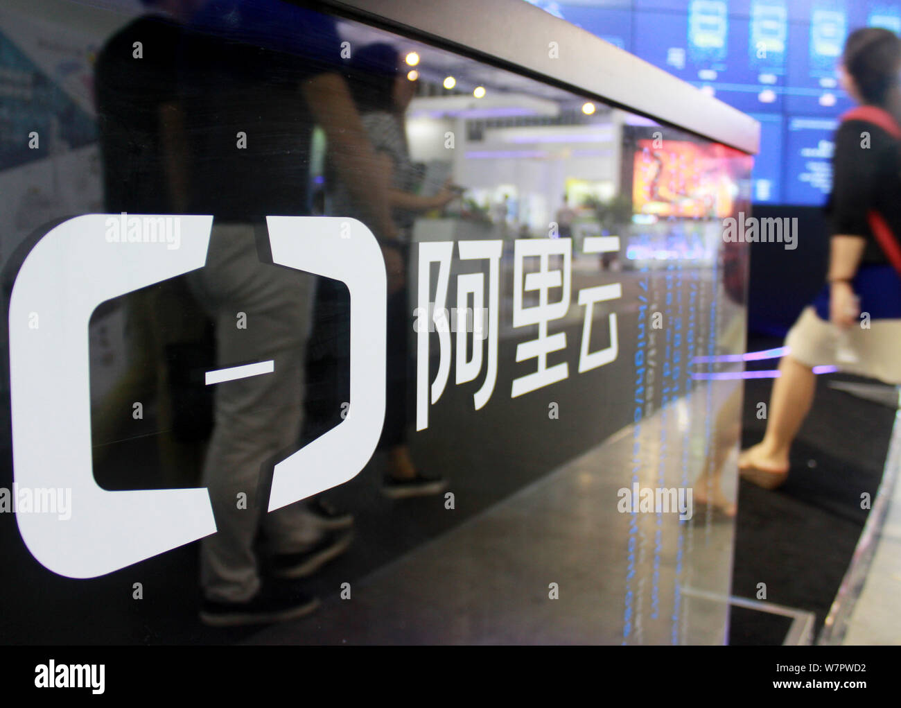 --FILE--A visitor walks past the stand of Aliyun.com, the online cloud ...