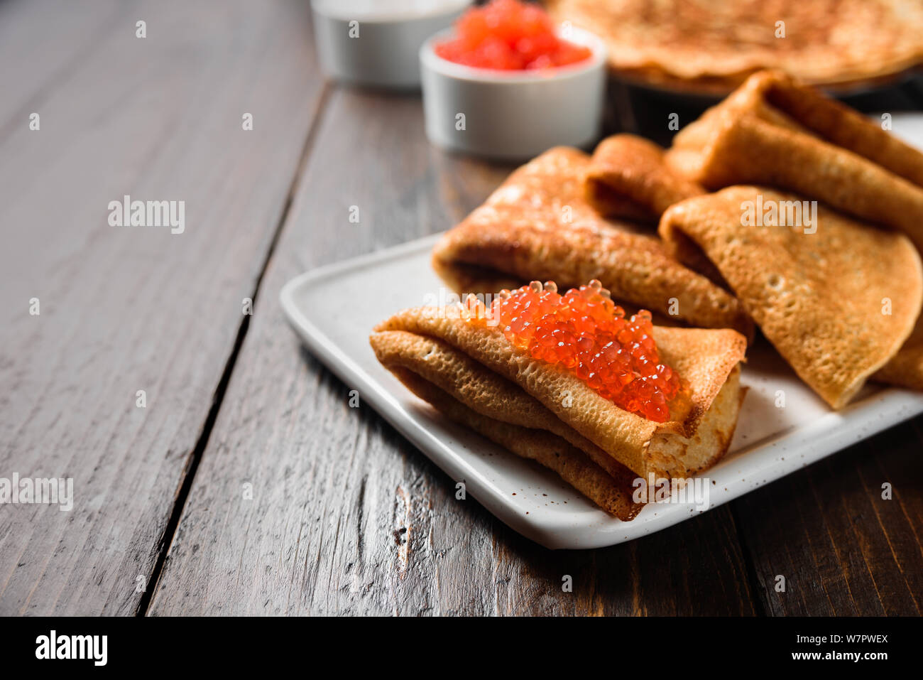 Russian pancakes blini with red caviar on wooden background Stock Photo ...