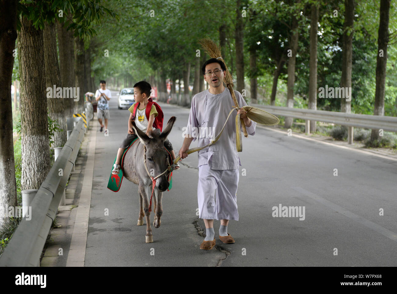 The three-year-old child is on the way to go to preschool on the back ...