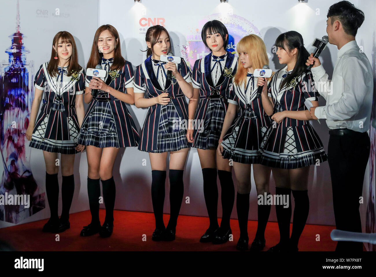Members of Chinese girl group SNH48 attend a press conference for 2016 ...